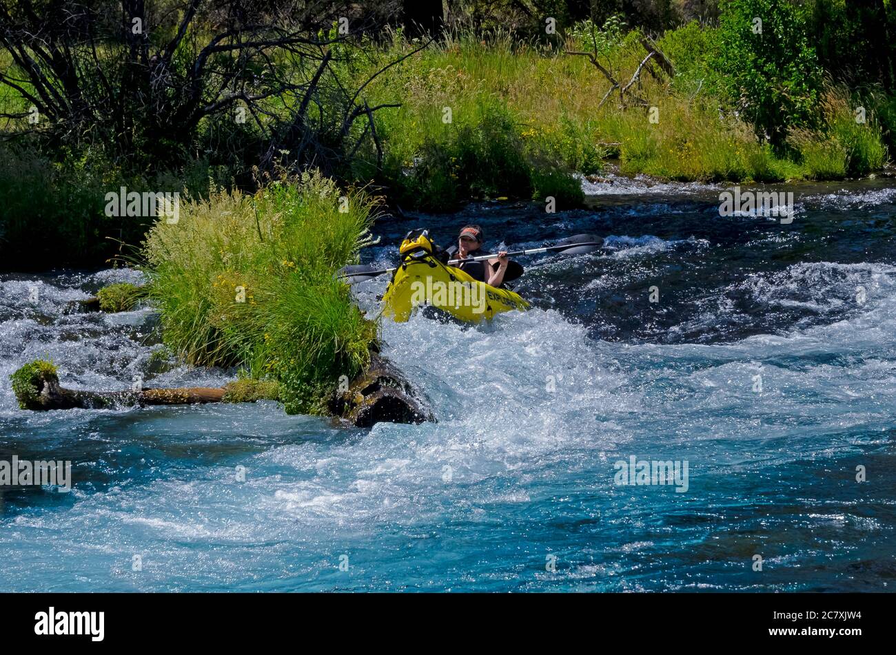 Kayak tipping over while going over the rapids Stock Photo - Alamy