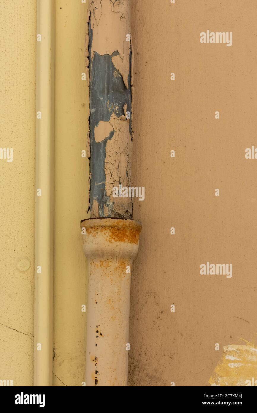 Vertical picture of a rustic pipe on the wall Stock Photo - Alamy
