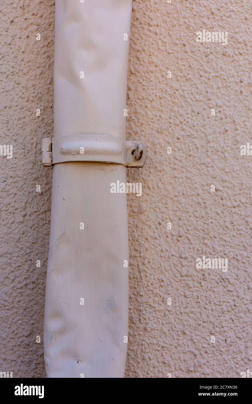Vertical picture of a rustic pipe on the wall Stock Photo - Alamy