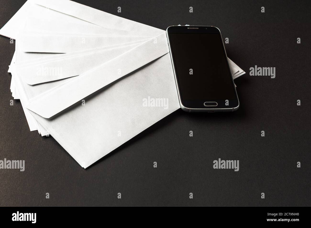 black office desk table with smartphone with blank screen on top of ...