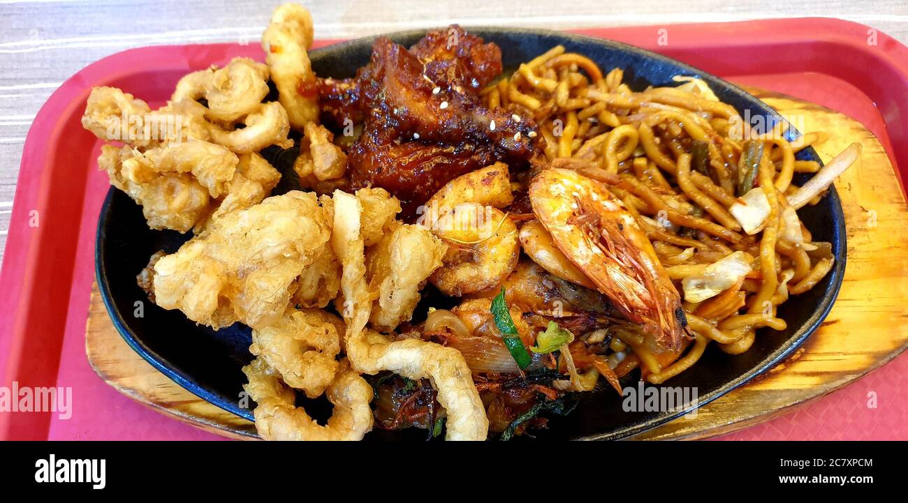 Closeup shot of a dish made of a variety of grilled meats mixed with ...