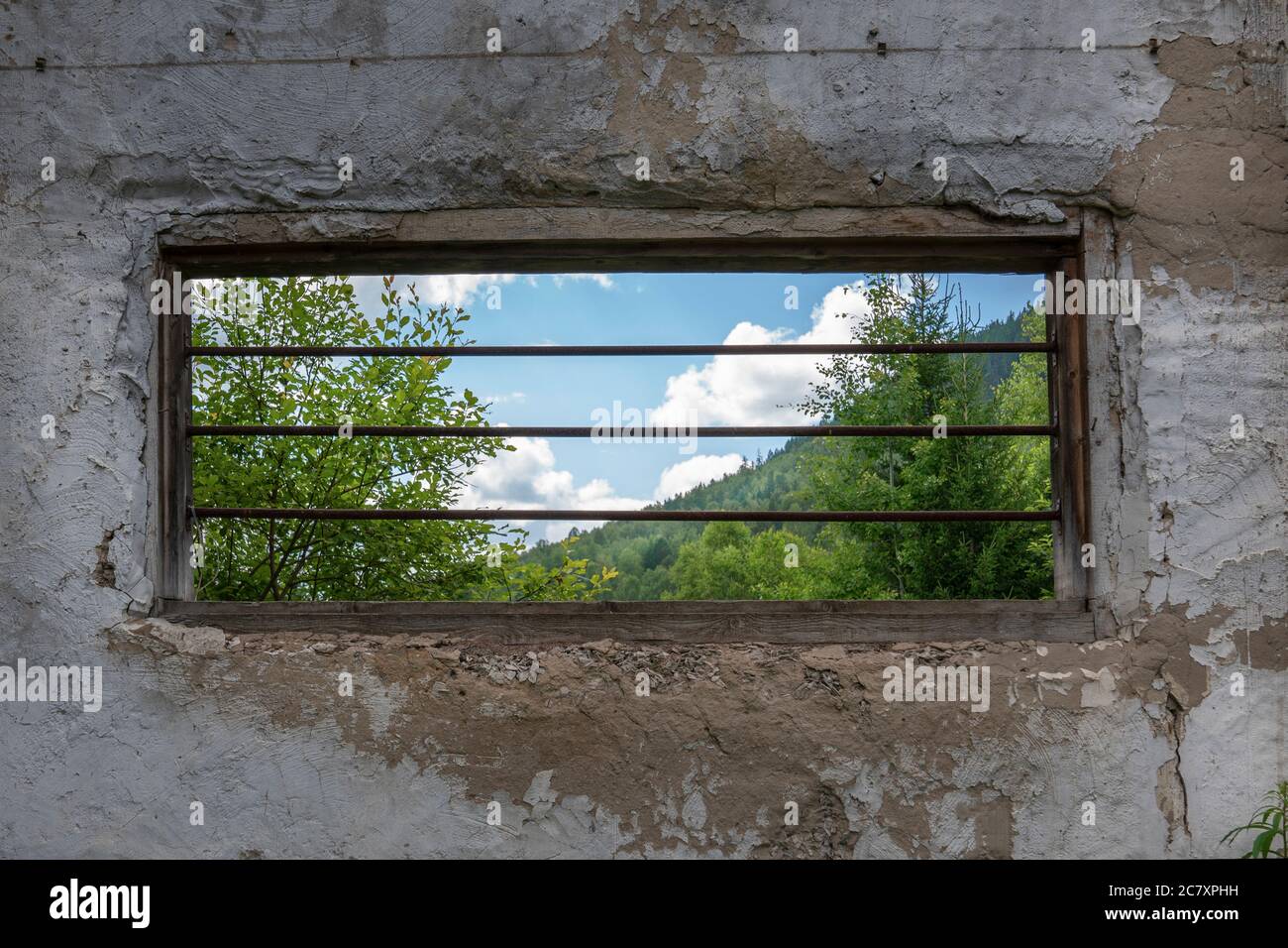 an elongated window with bars in an old building overlooking a ...