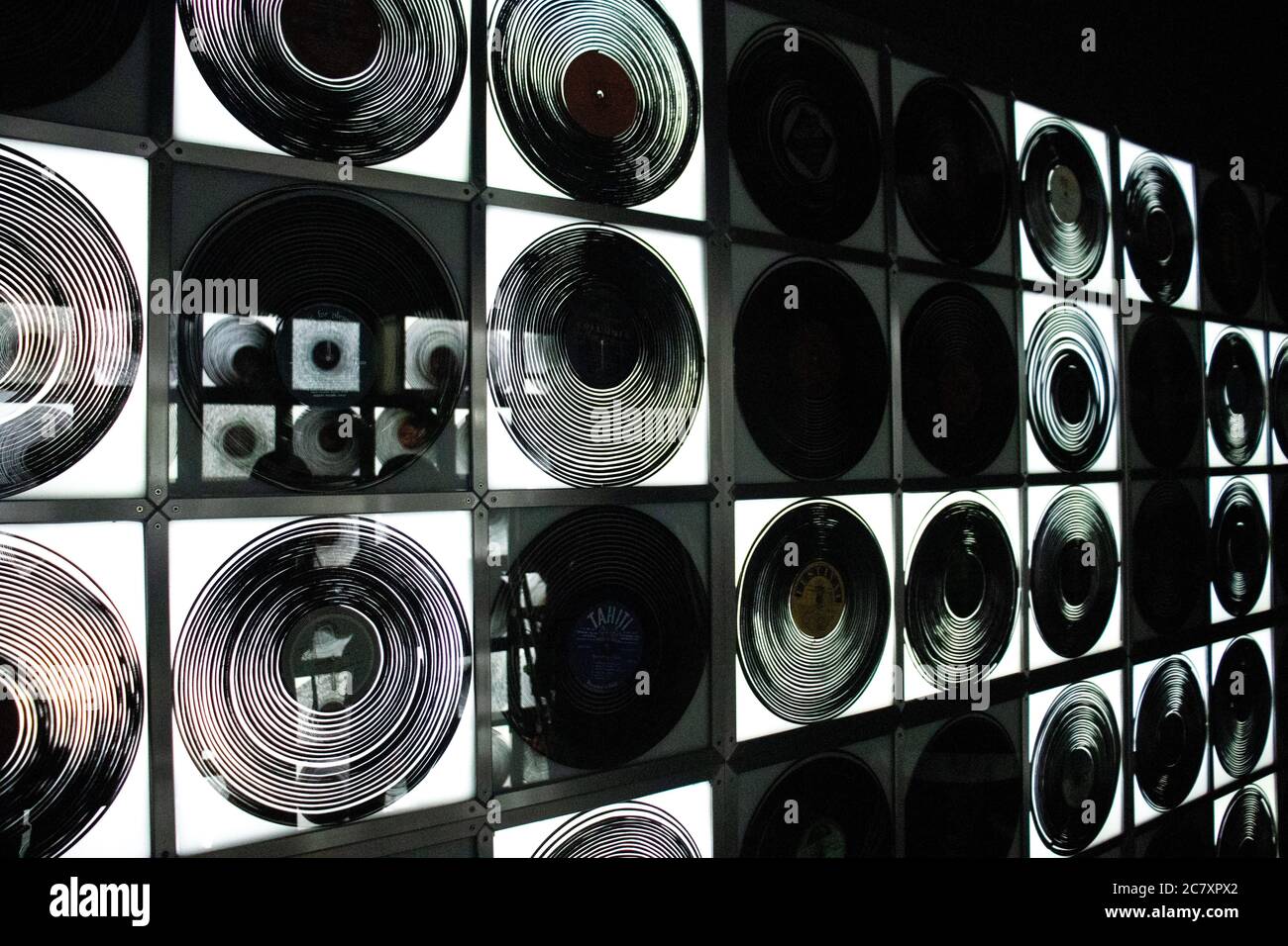 Vinyl records with back lighting and displayed on a wall grid Stock ...