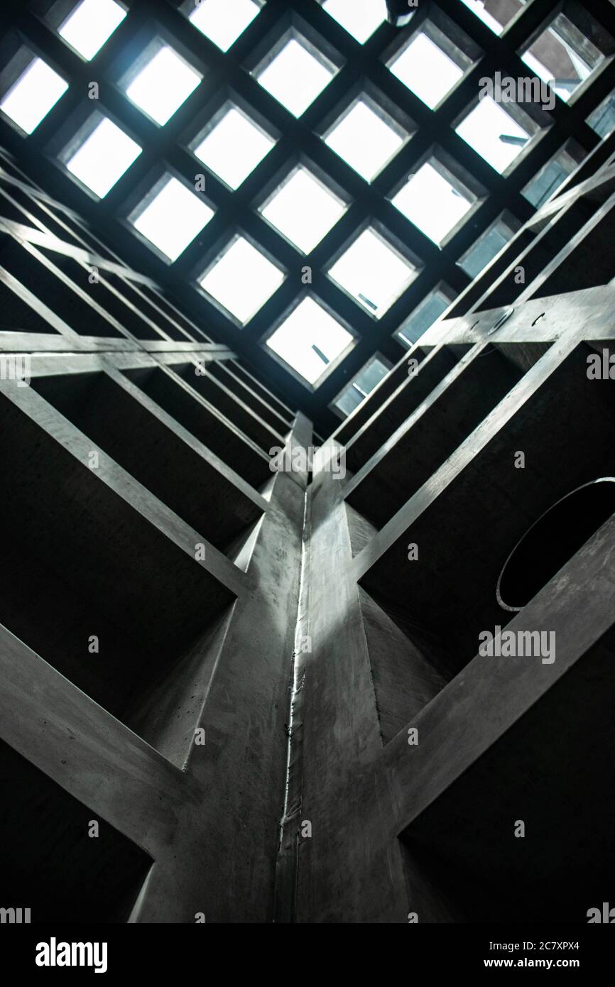 Concrete lattice structure with the end of a pipe leading to a grid ...
