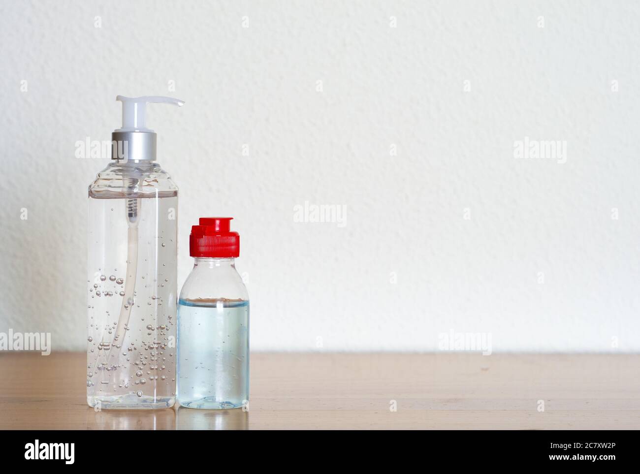 Big and small hand sanitizer gel containers on white background Stock ...