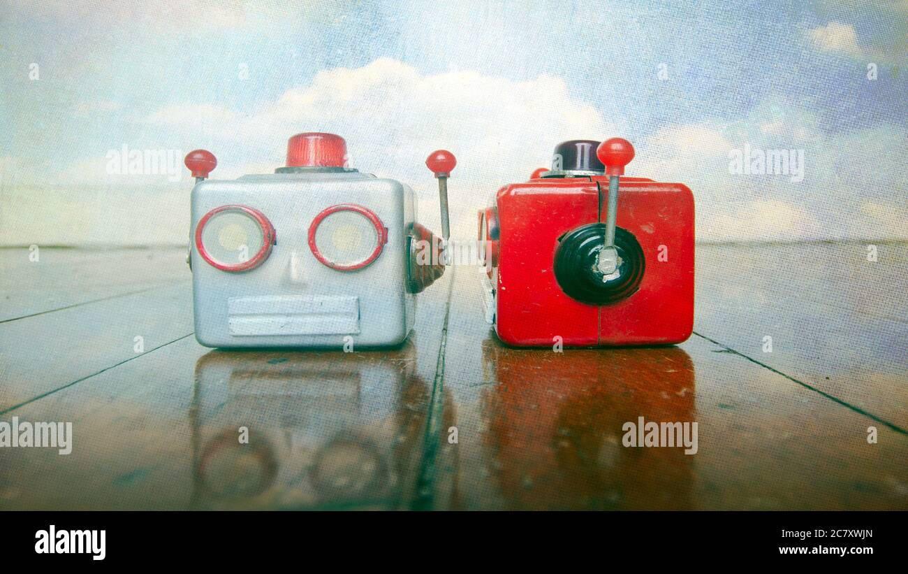 two robot heads chatting on a old wooden floor Stock Photo - Alamy
