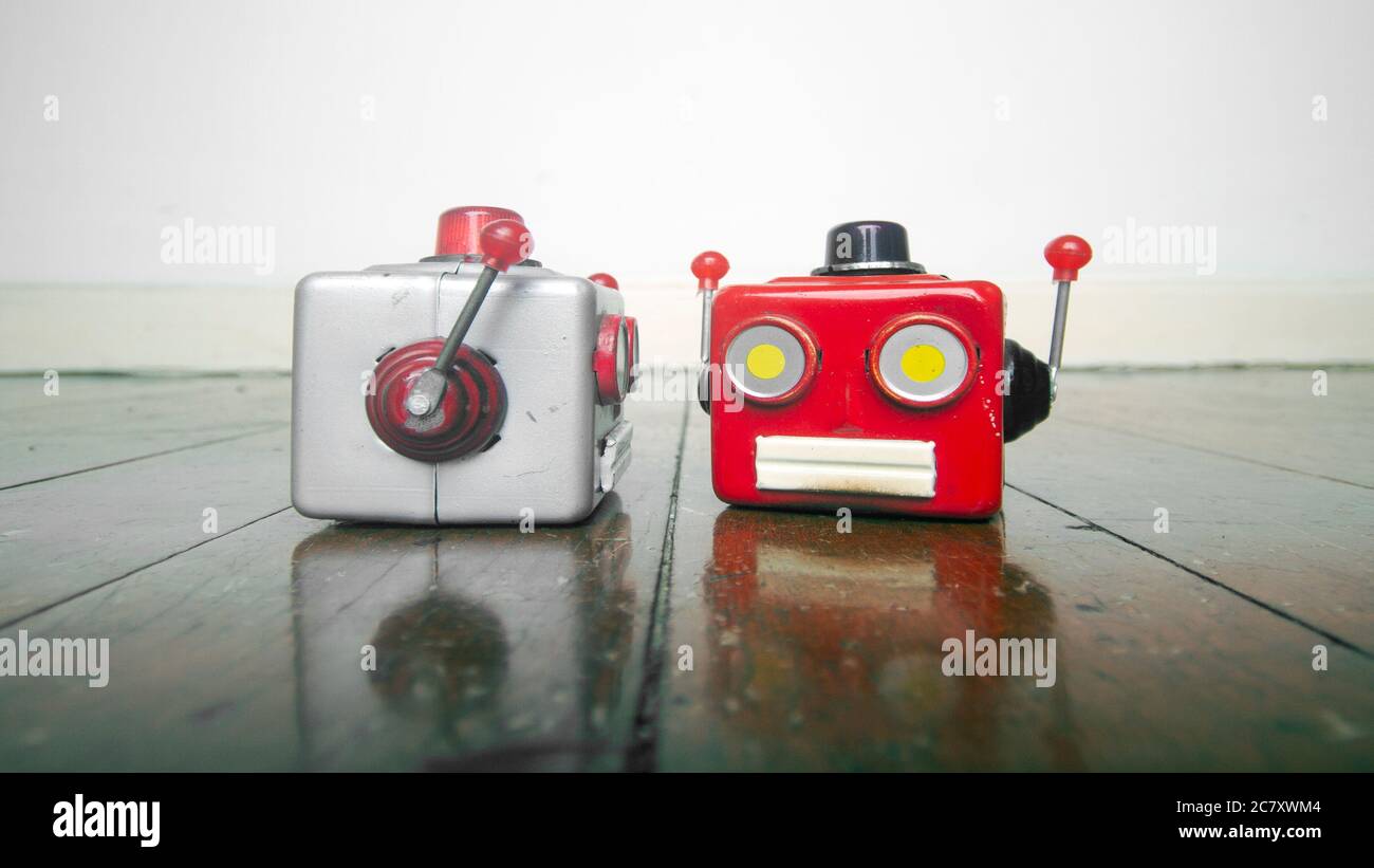 two robot heads chatting on a old wooden floor Stock Photo - Alamy