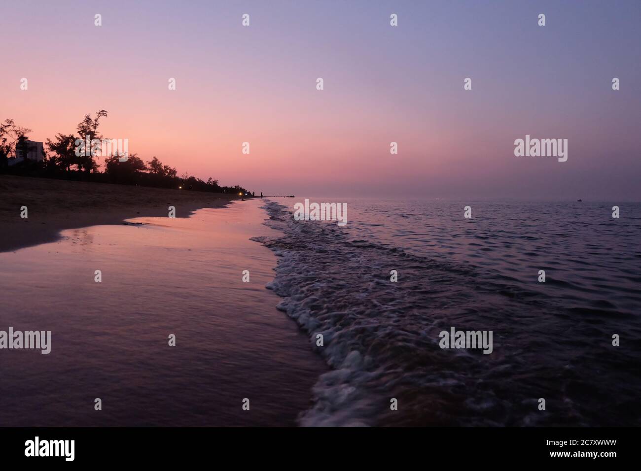 perspective straight coastline under sunset purple sky Stock Photo - Alamy