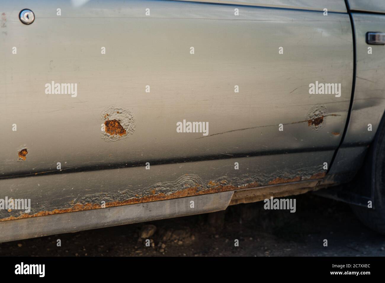 Car door with rust and metal corrosion. Rust stains. Need repairs, road ...