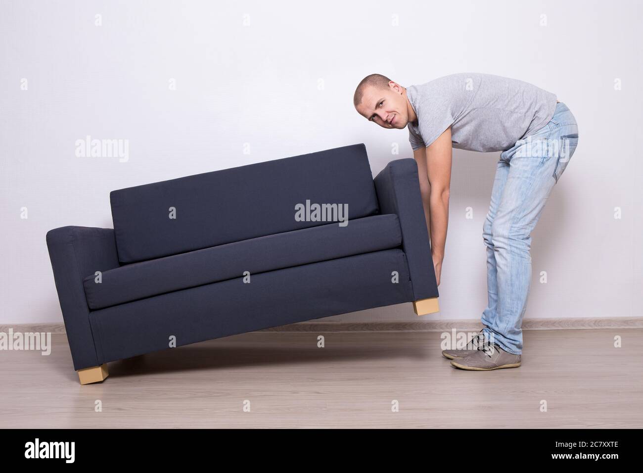 Mover guy lifting up couch hi-res stock photography and images - Alamy