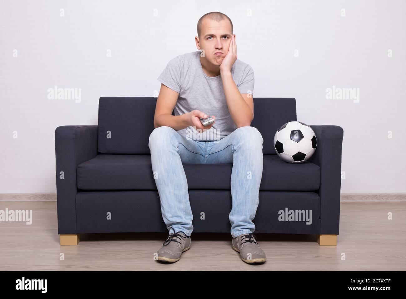 bored soccer fan watching game on tv at home Stock Photo - Alamy