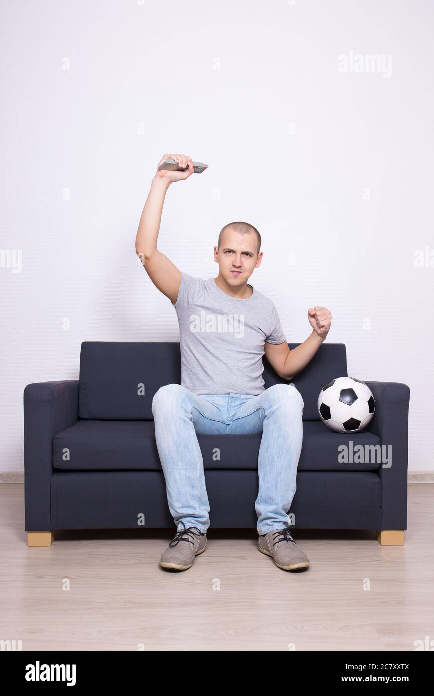 happy soccer fan watching game on television Stock Photo - Alamy