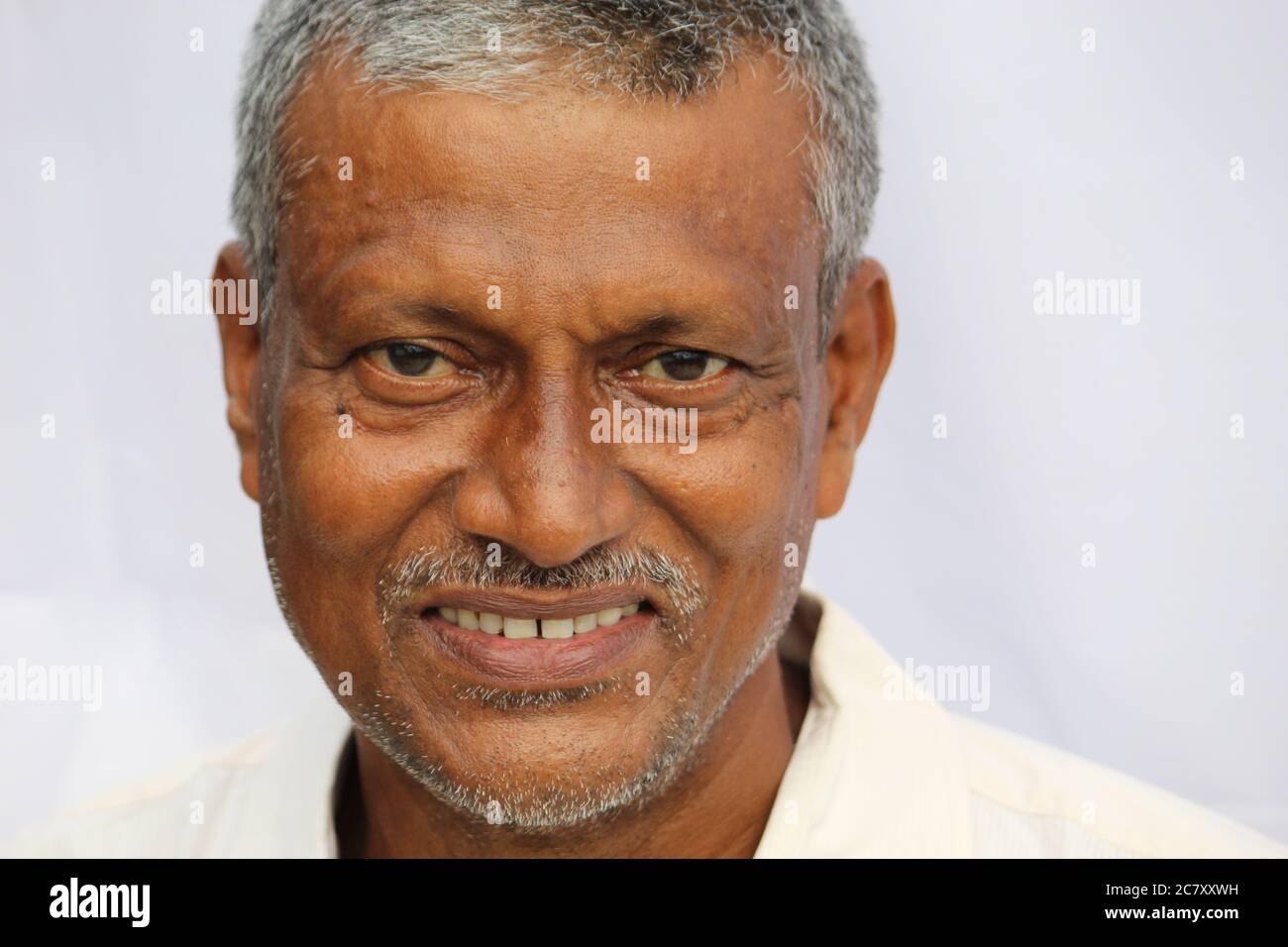 Smiling Indian senior man face portrait on white background Stock Photo ...