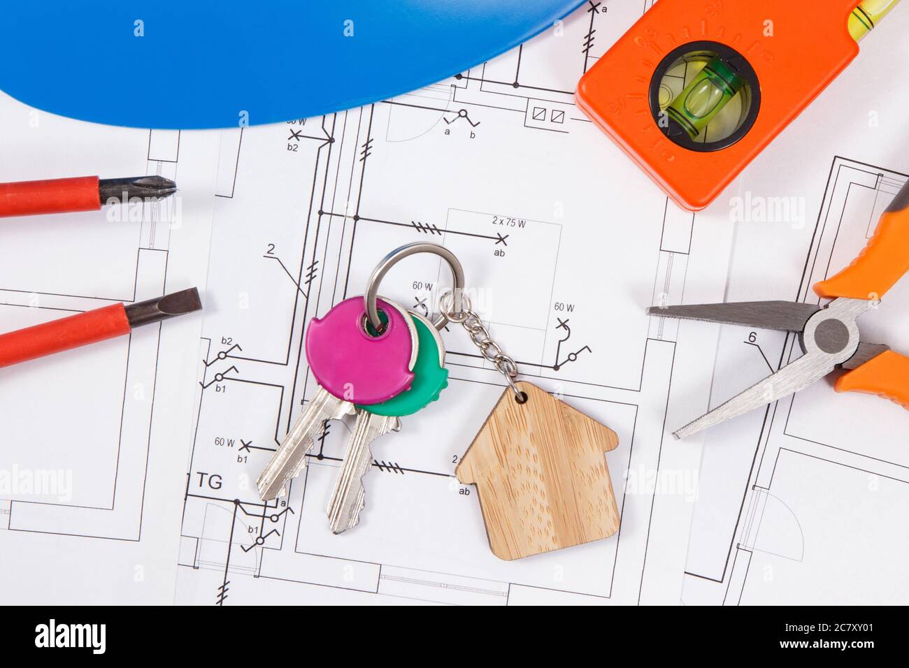 Keys with house shape and electrical construction drawings with work ...