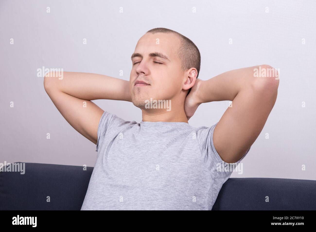 Young guy napping on sofa hi-res stock photography and images - Alamy