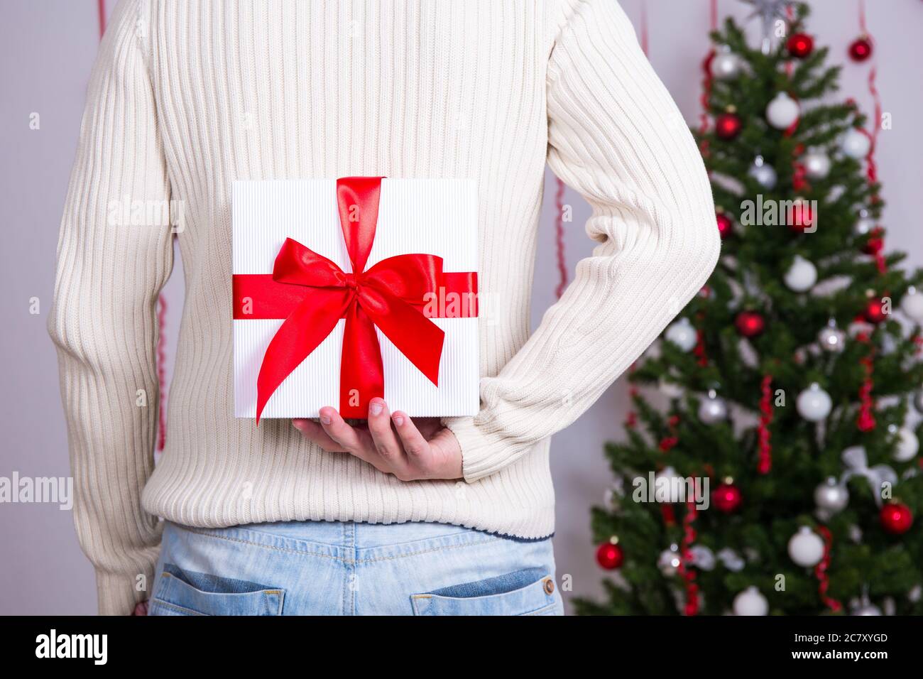 Christmas surprise concept - man hiding gift box behind back Stock ...