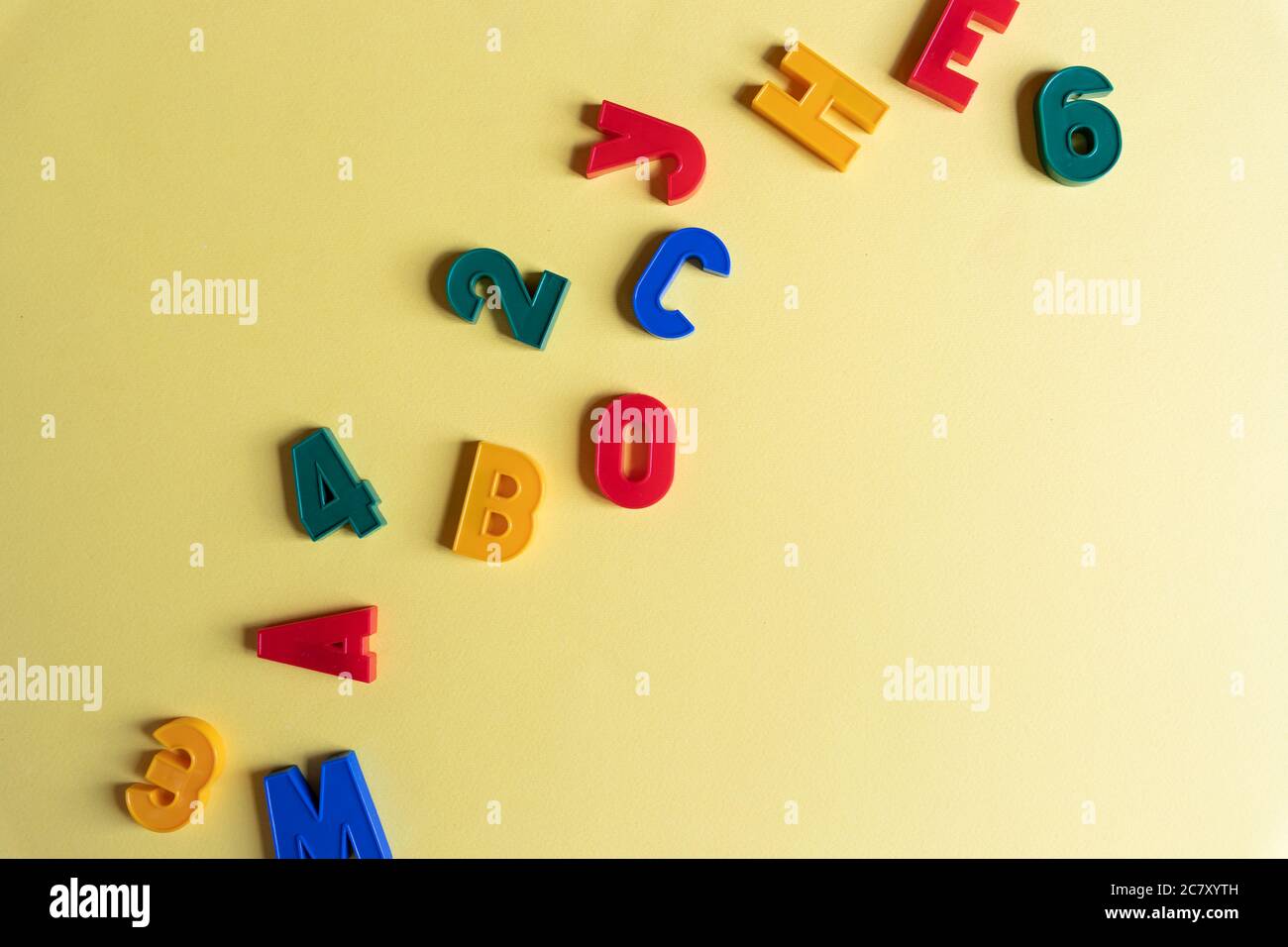 Multi-colored English letters and numbers on yellow background. Kid's ...