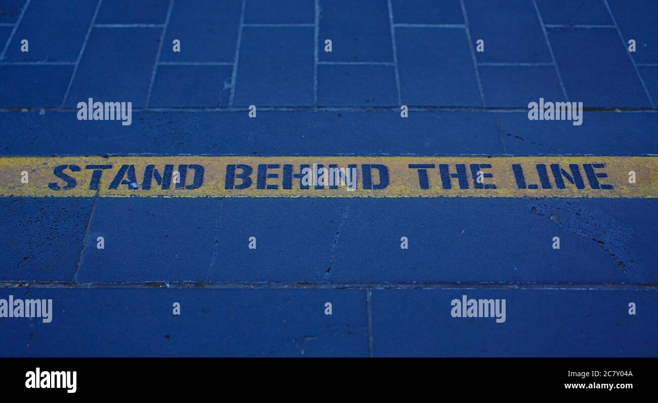 Stand behind yellow line sign hi-res stock photography and images - Alamy