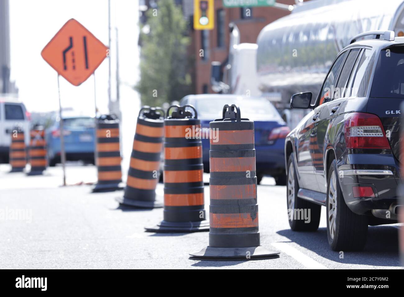 Motor vehicle follow detour shown by cones and signs to avoid road ...