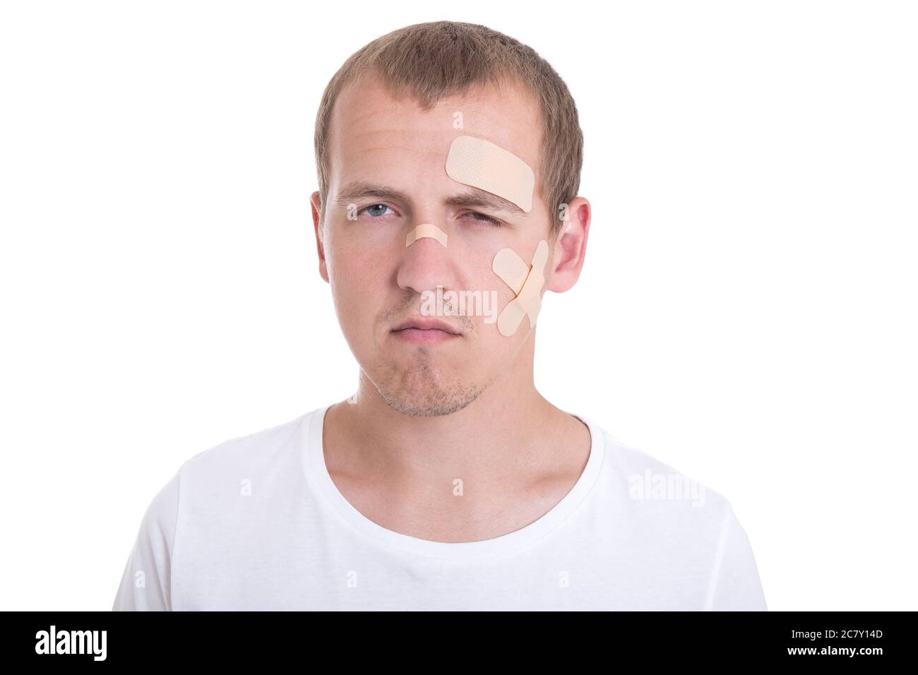 sad and injured young man with adhesive plaster on his face Stock Photo ...