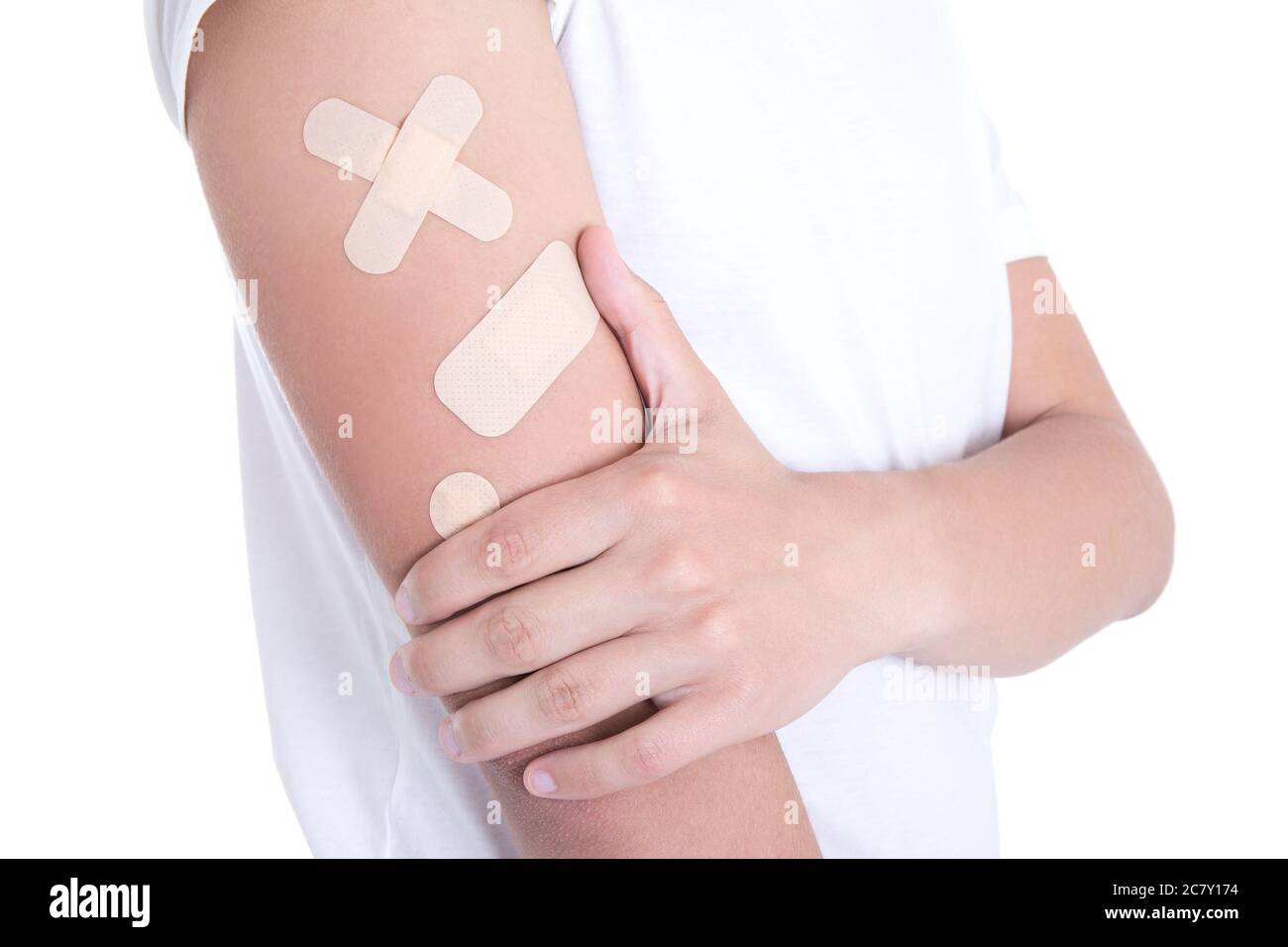 different medical adhesive plasters on male hand isolated on white ...