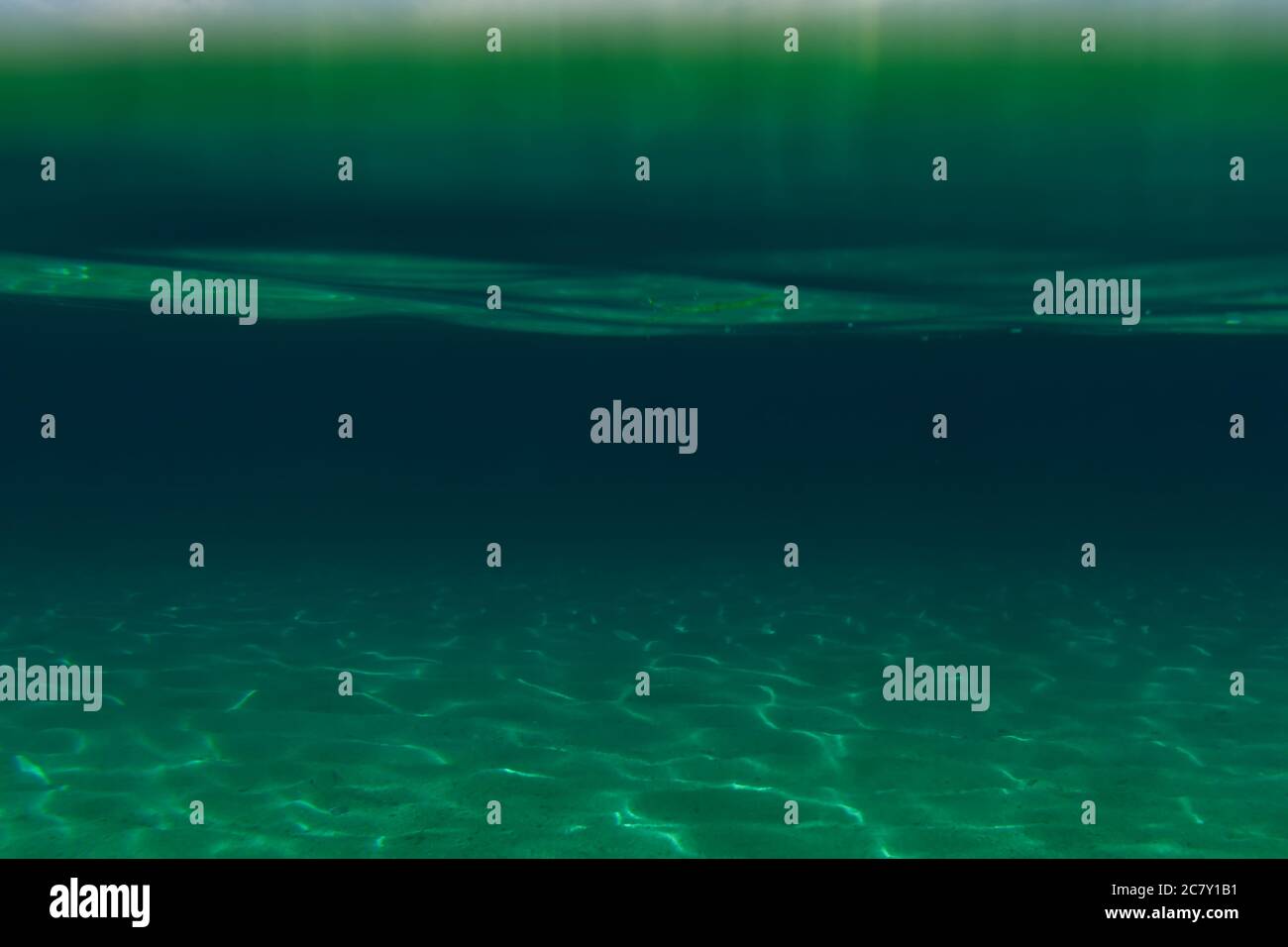 Summer time under the sea ocean water with a ray of sunlight from the ...