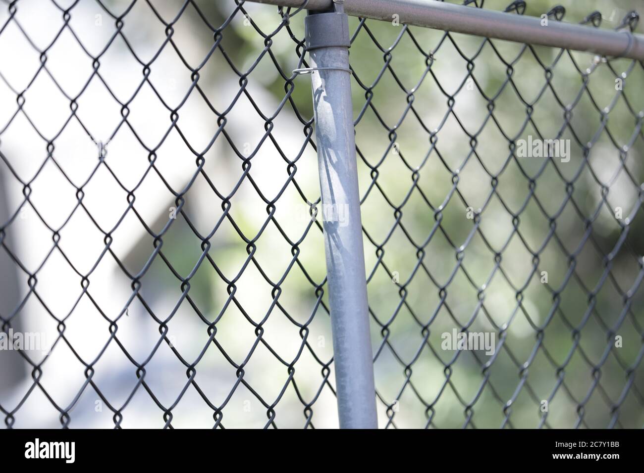 Chain Link fence and metal post in selective focus Stock Photo - Alamy
