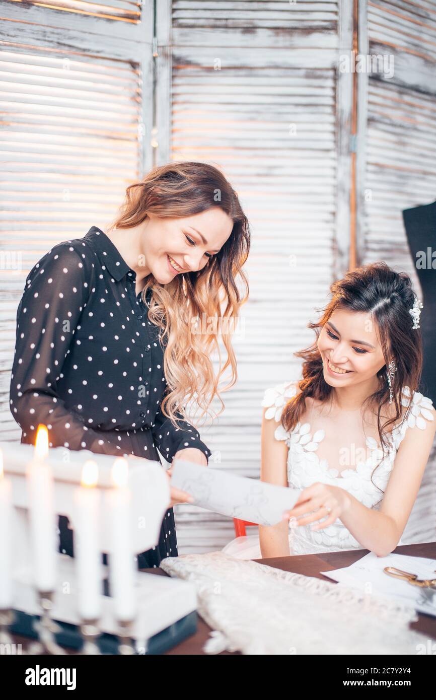 fashion designer and client choosing color for new dress in the ...