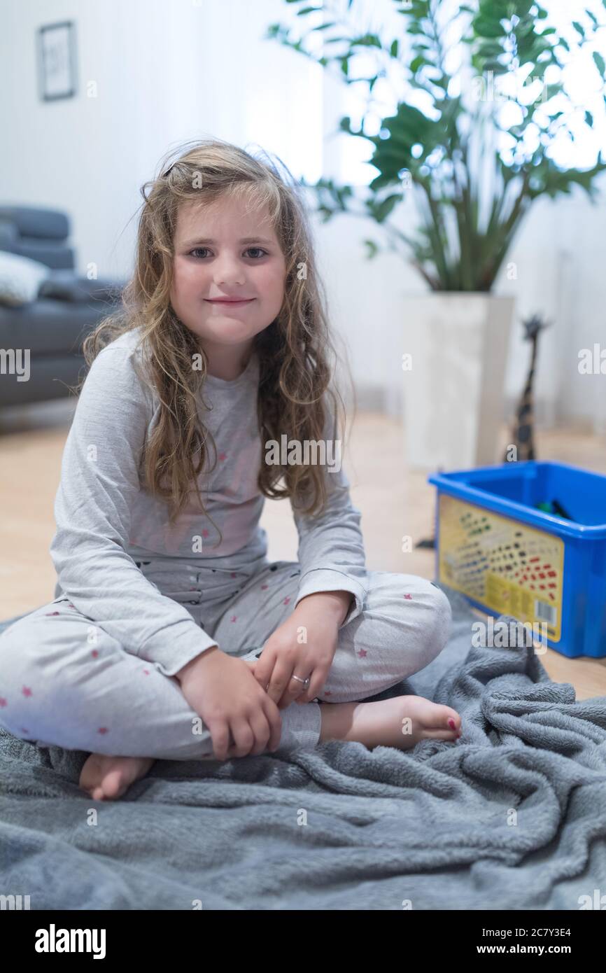 Portrait of a cute little Caucasian girl child with disheveled hair ...