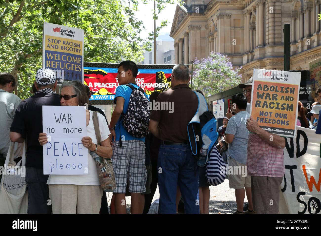 Protesters hold signs against war and racism at a rally against war in ...