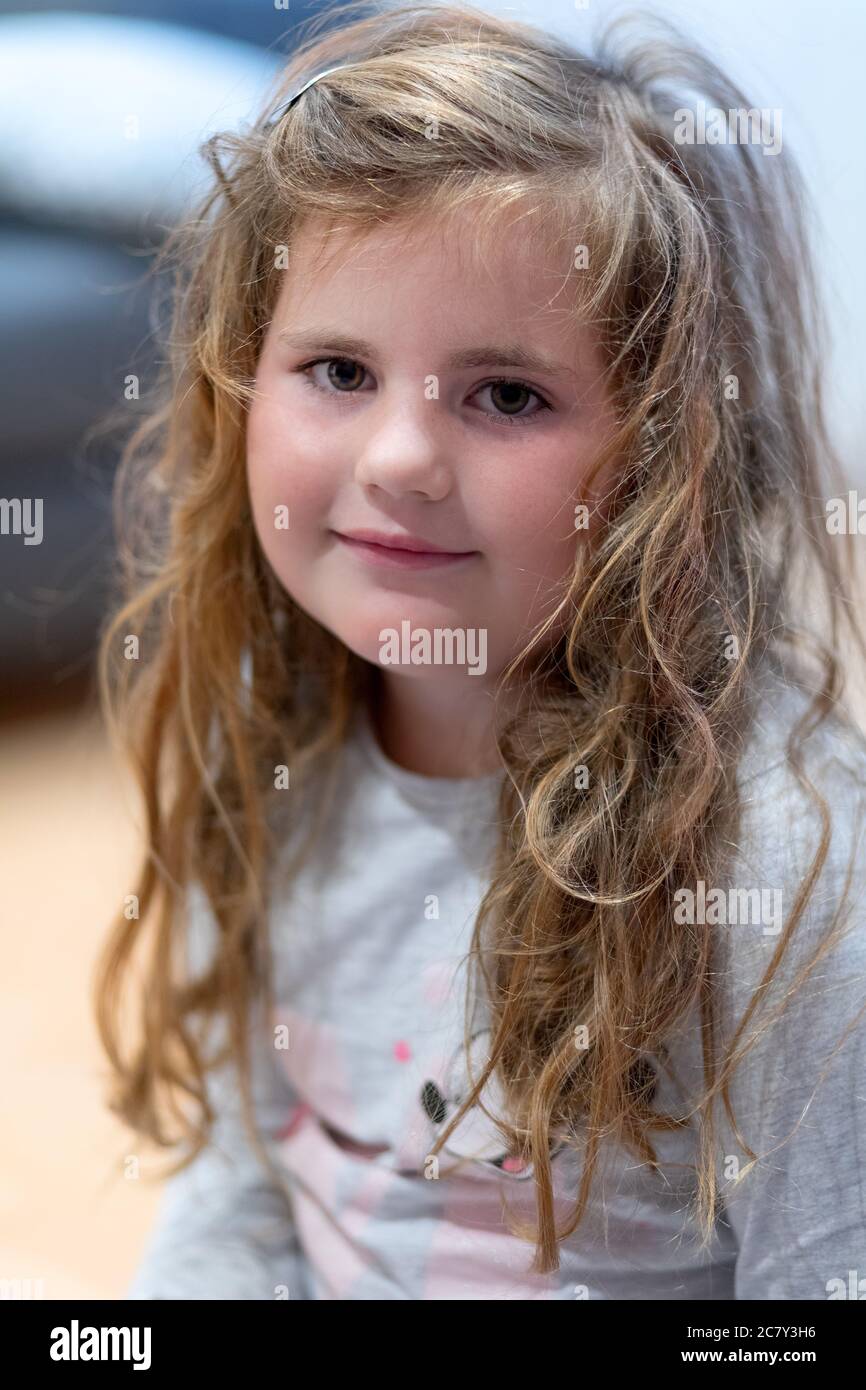 Portrait of a cute little Caucasian girl child with disheveled hair ...