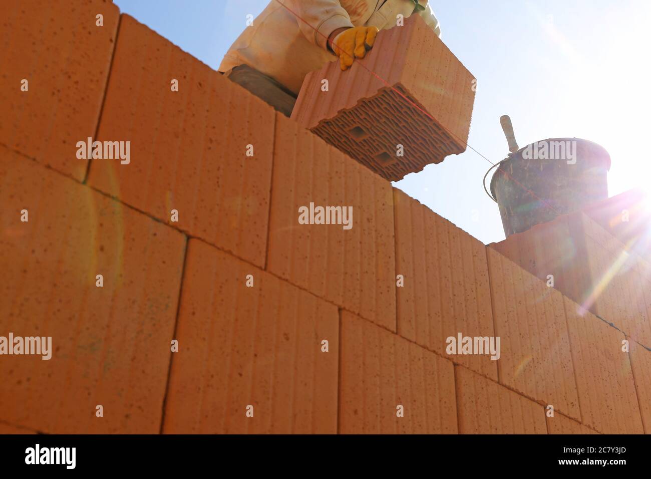 Construction worker (bricklayer) works on the construction site Stock ...