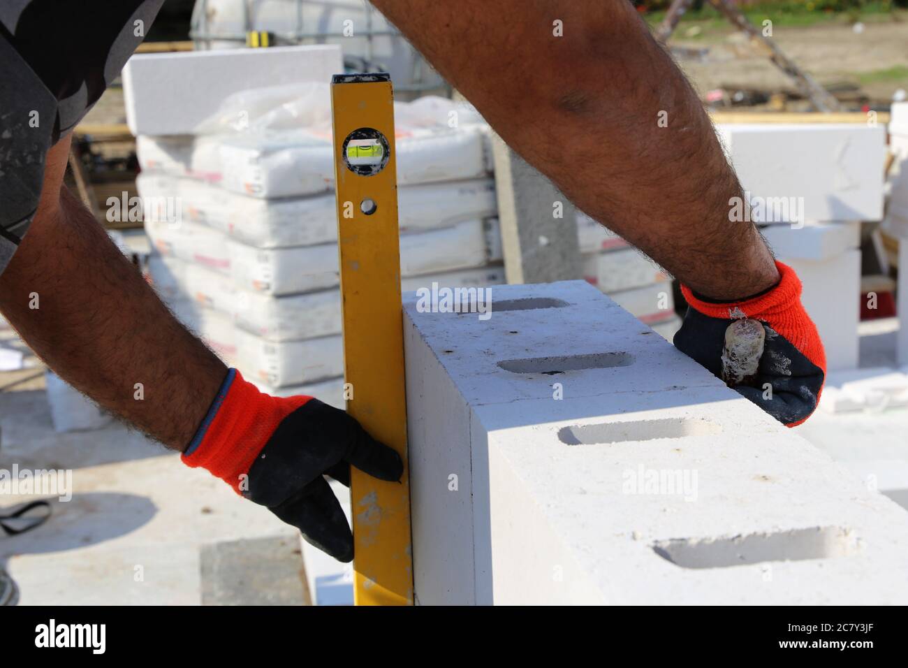 Construction worker (bricklayer) works on the construction site Stock ...
