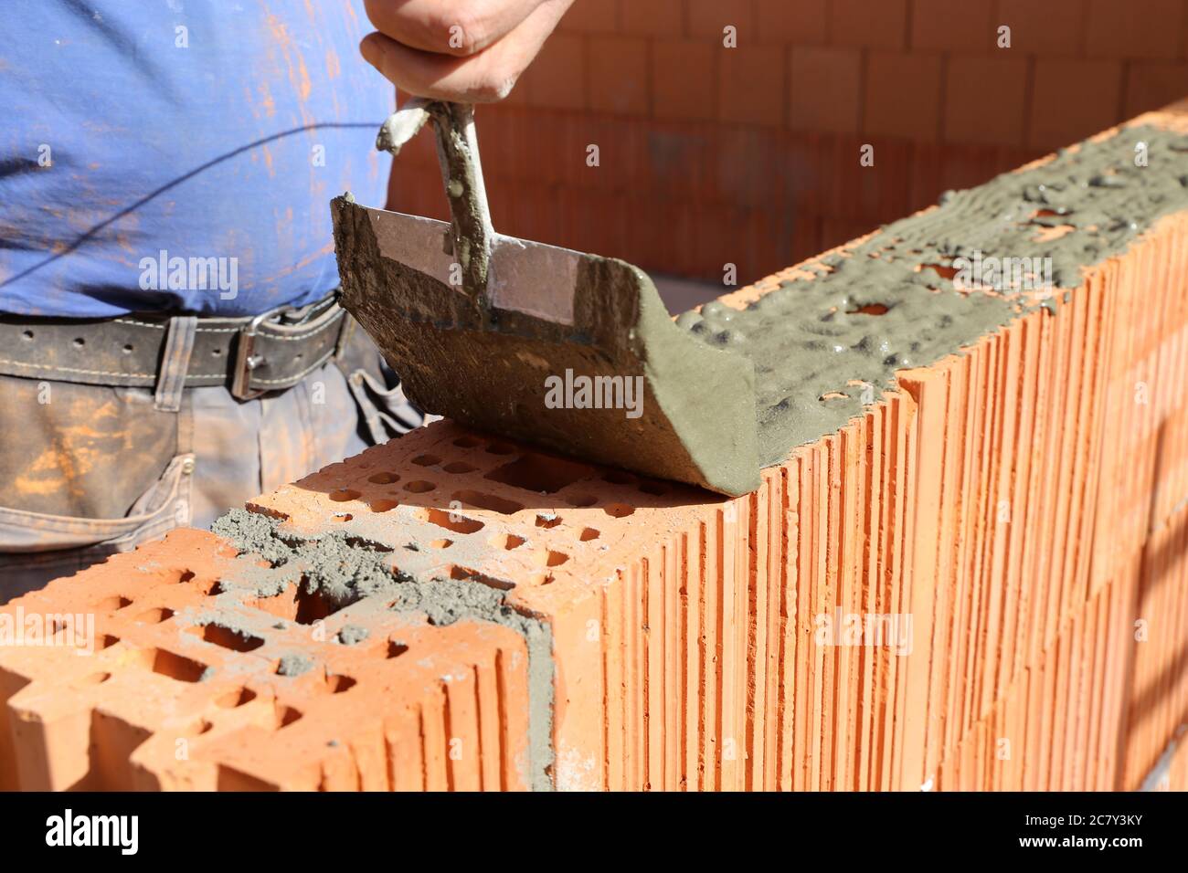 Construction worker (bricklayer) works on the construction site Stock ...