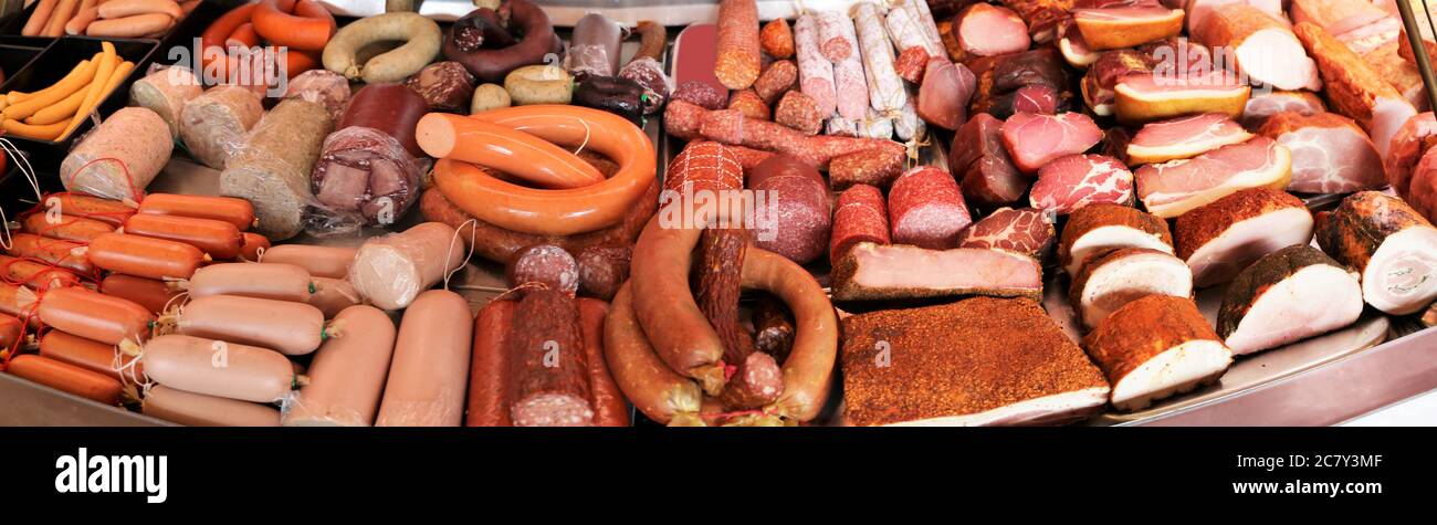 Panoramic picture of a sausage counter in a butcher's Stock Photo - Alamy