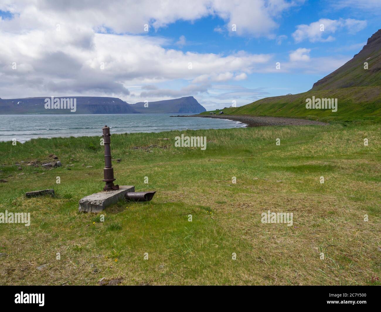 View on adalvik cove with rusty water pump and summer cottages at ...