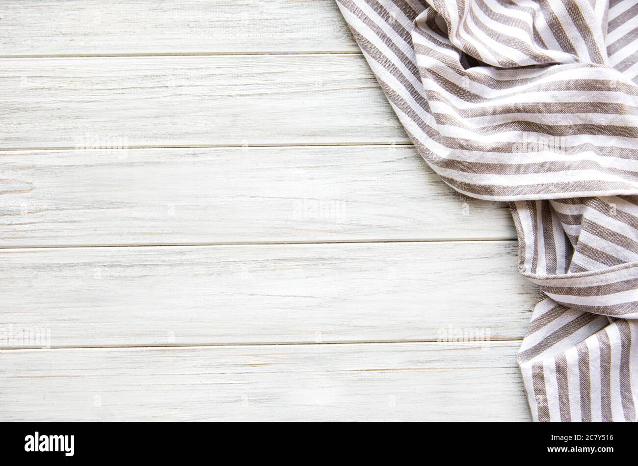 Beige folded kitchen cloth on wooden background, top view Stock Photo ...