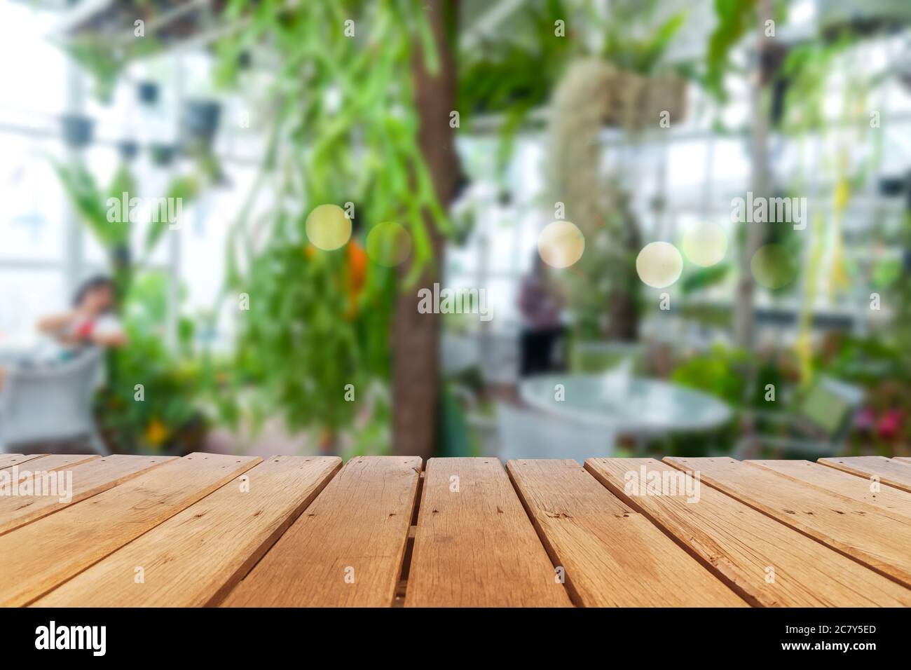 Selective focus of wooden table with blur coffee and restutant cafe ...