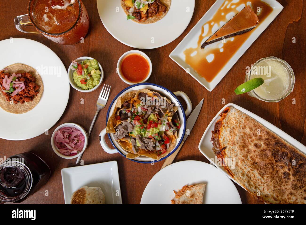 Dinner table with nachos, tacos, and a special dessert Stock Photo - Alamy