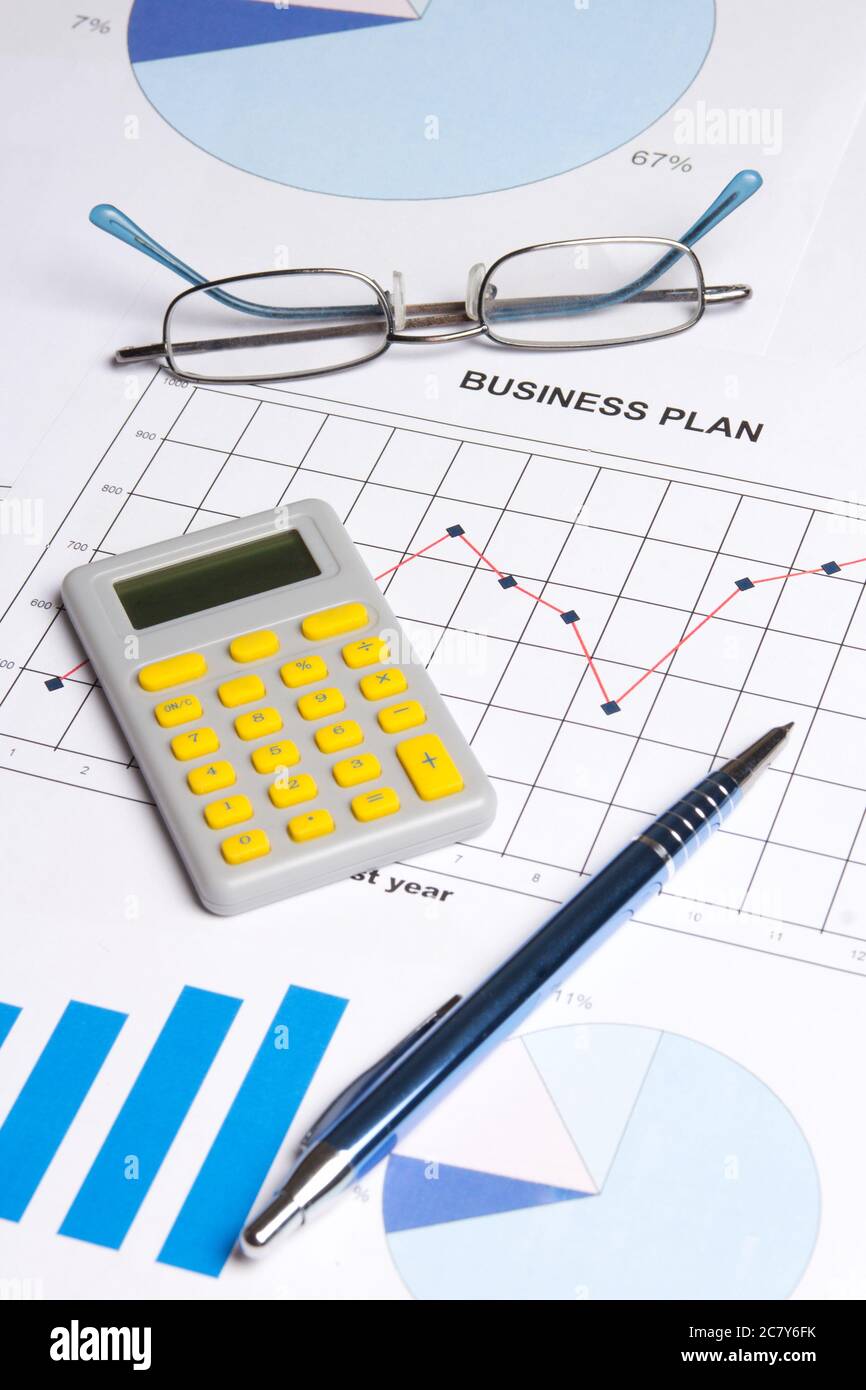 business plan with graphs, charts and calculator on the table Stock ...