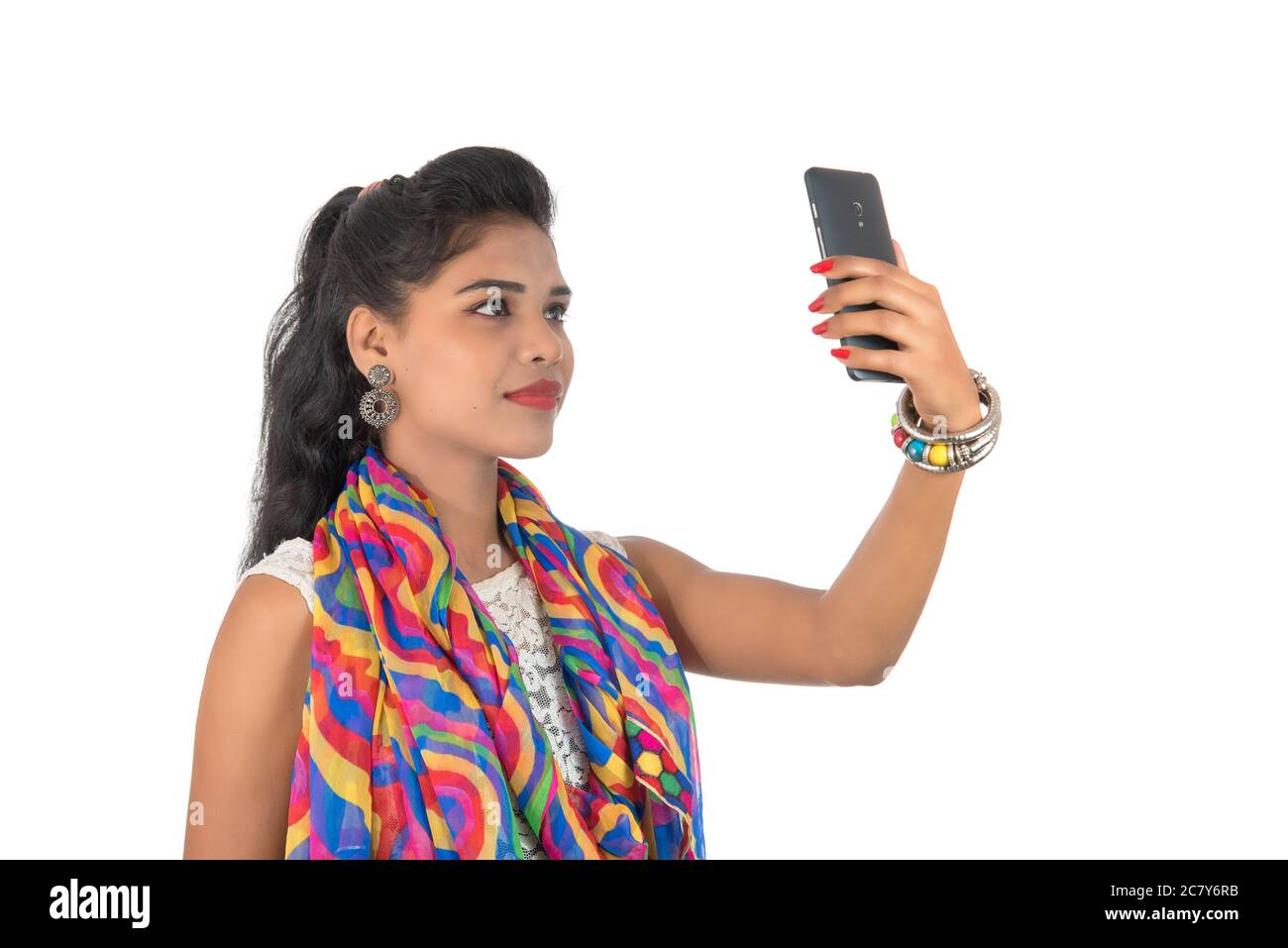 Young Indian girl using a mobile phone or smartphone isolated on a ...