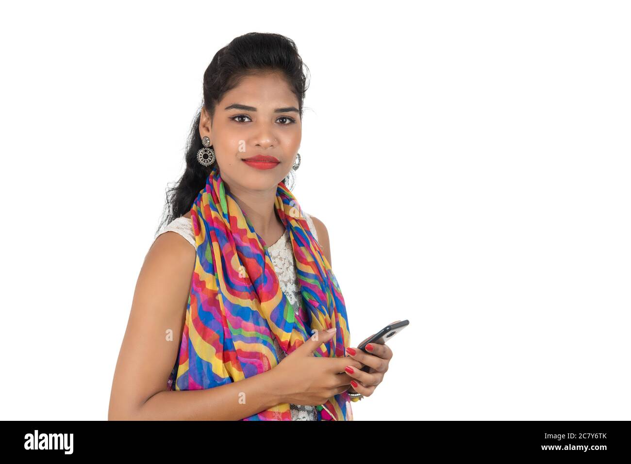 Young Indian girl using a mobile phone or smartphone isolated on a ...