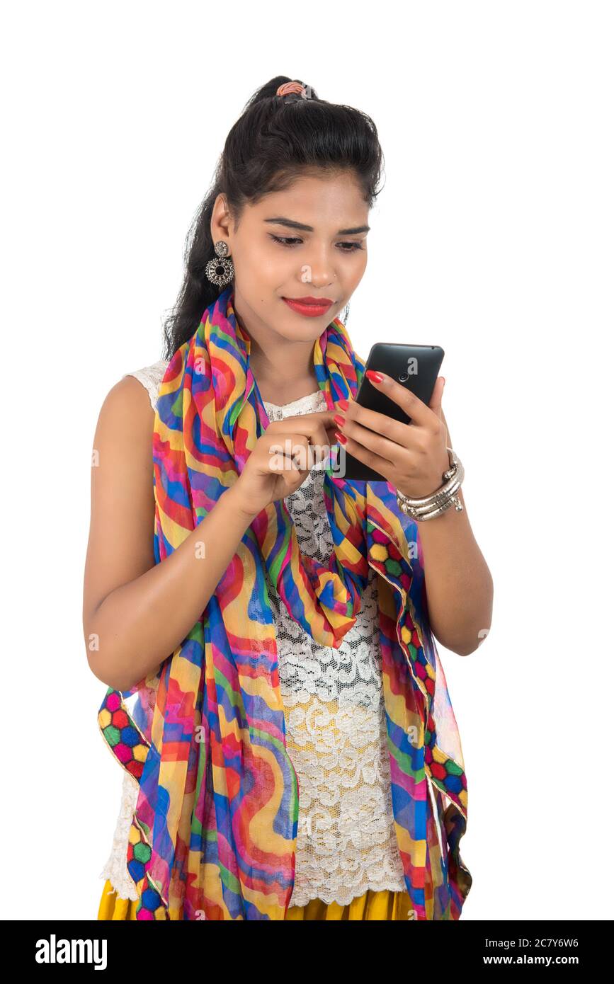 Young Indian girl using a mobile phone or smartphone isolated on a ...