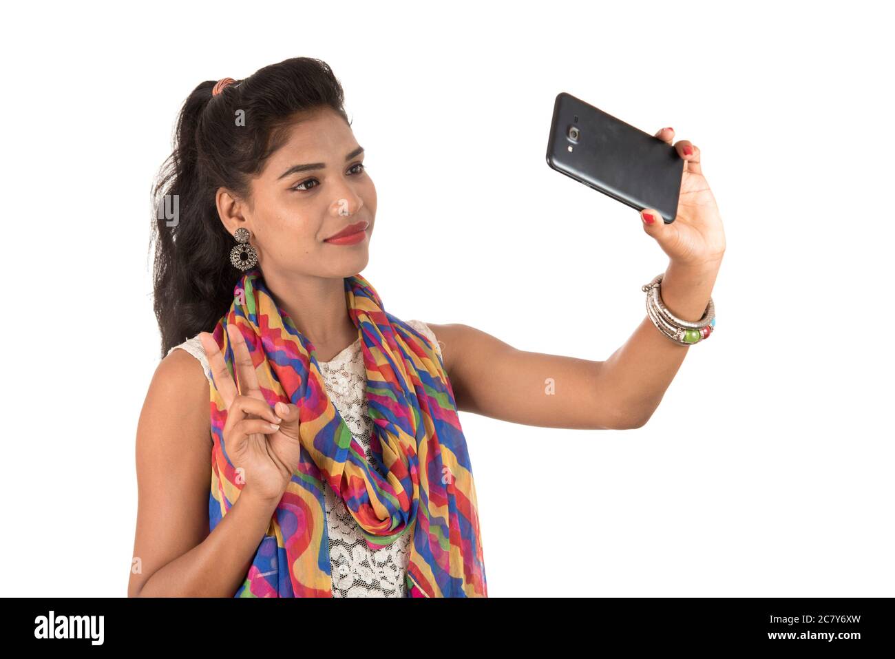 Young Indian girl using a mobile phone or smartphone isolated on a ...