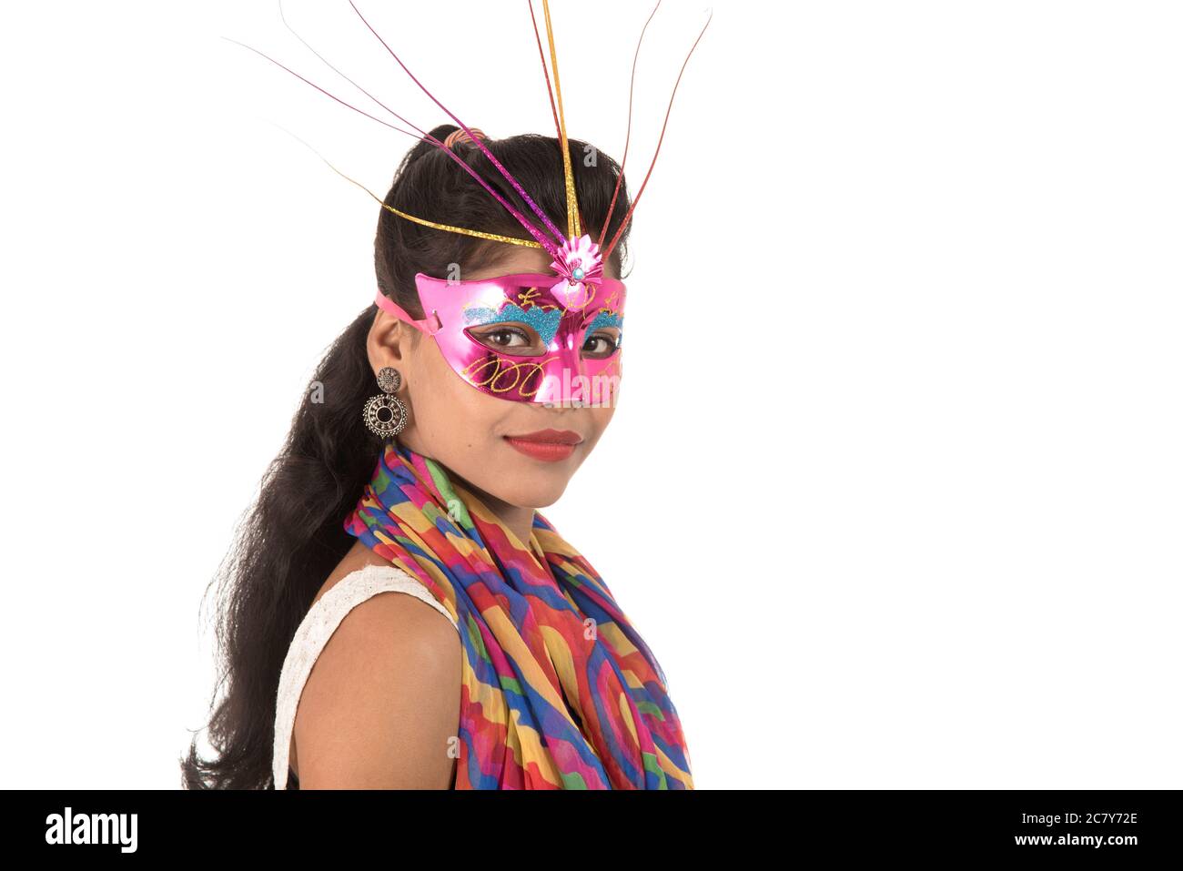 Smiling cheerful girl wearing carnival mask isolated on white ...