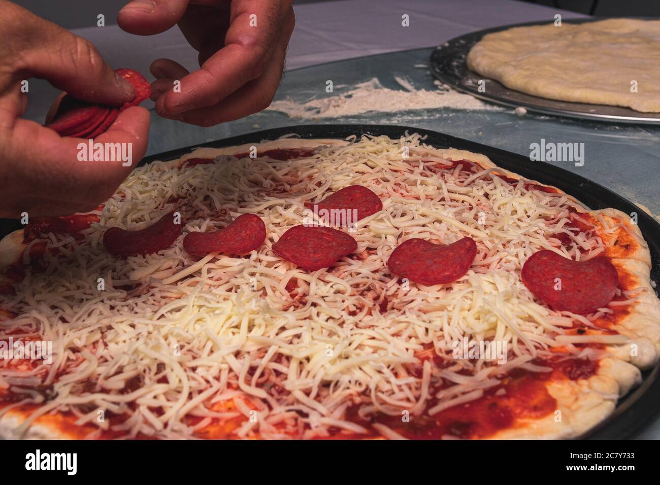Process of preparing homemade pepperoni pizza Stock Photo - Alamy
