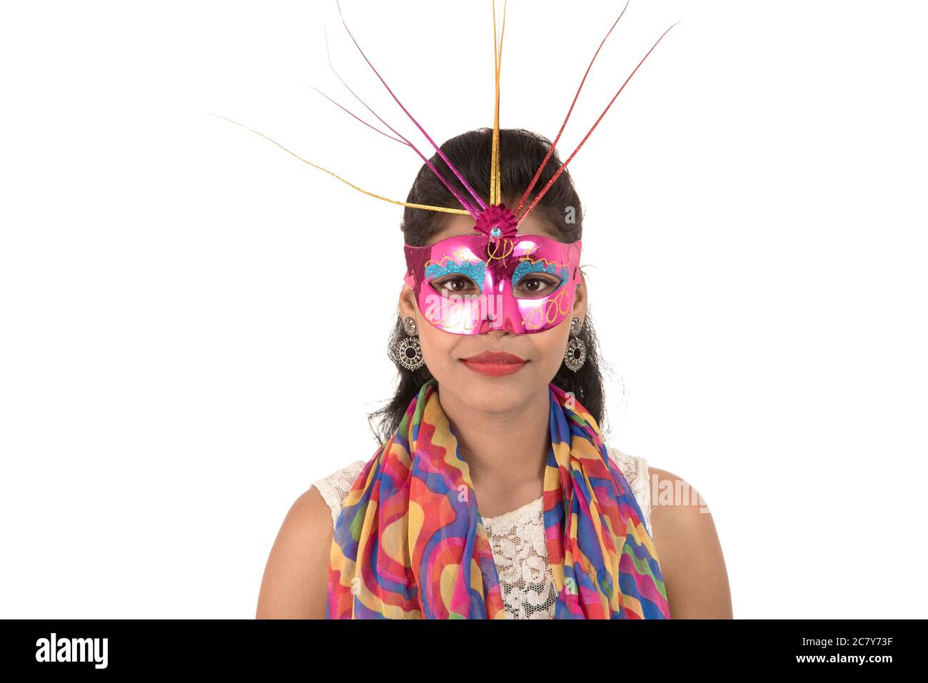 Smiling cheerful girl wearing carnival mask isolated on white ...