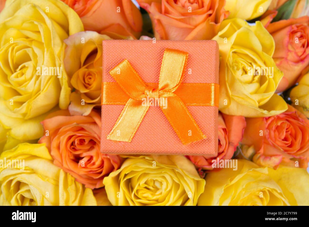 little gift box and beautiful bouquet of orange and yellow roses Stock ...