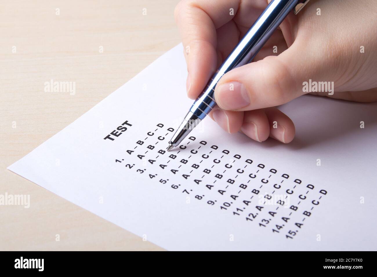 woman filling test score sheet with answers Stock Photo - Alamy