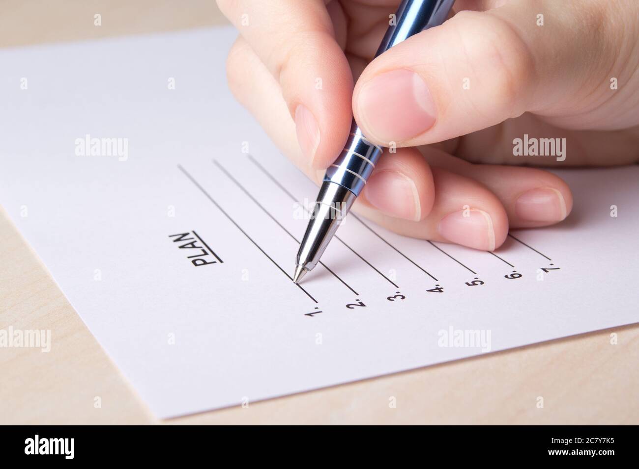 female hand filling plan list with blue pen Stock Photo - Alamy